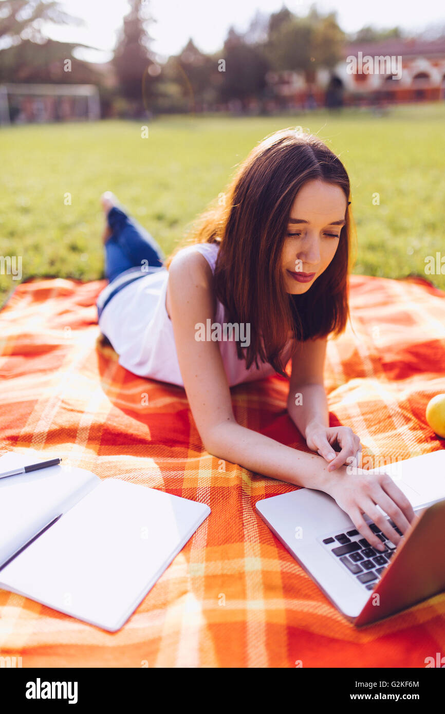 Student at the park learning at a laptop Stock Photo - Alamy