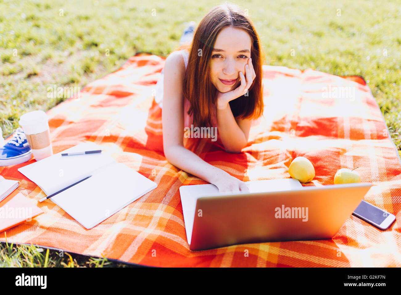 Student at the park learning with laptop Stock Photo - Alamy