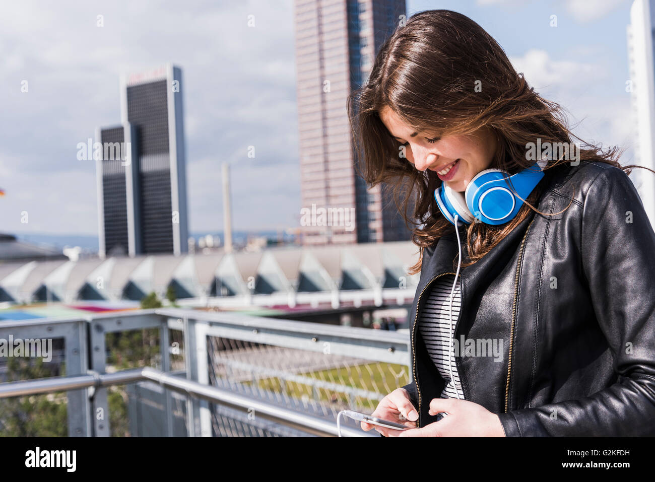 Young woman with headphones using smart phone Stock Photo - Alamy