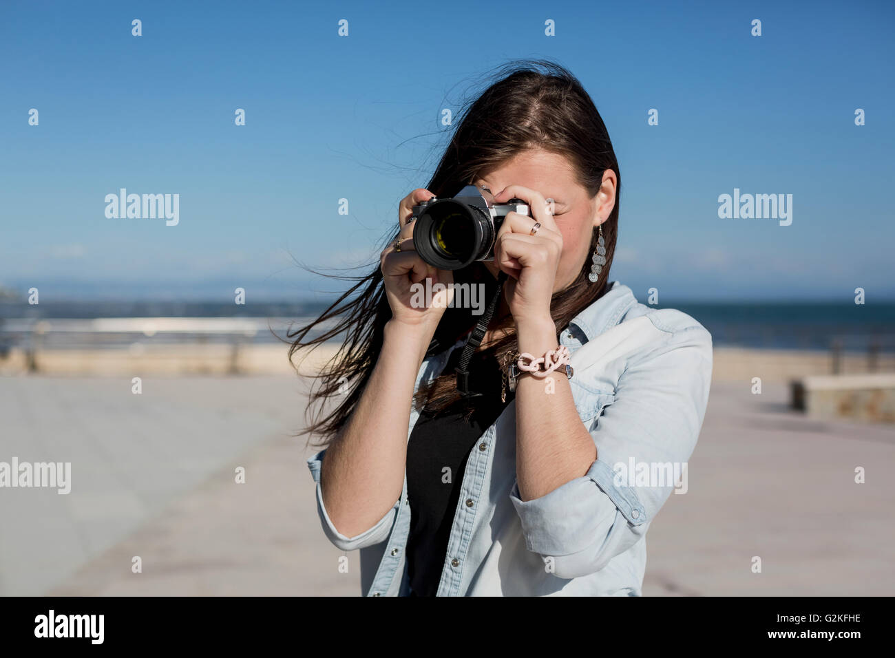 Young woman with camera Stock Photo - Alamy