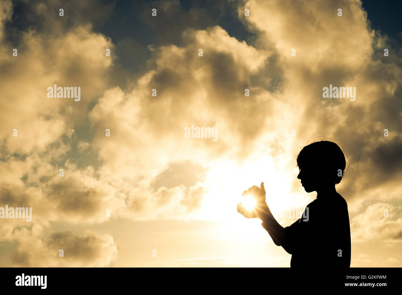 Boy catching the sun Stock Photo - Alamy