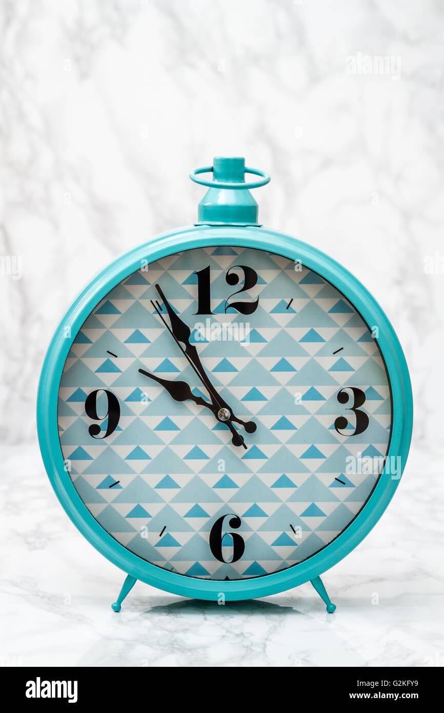 Blue retro alarm clock on white marble background Stock Photo - Alamy
