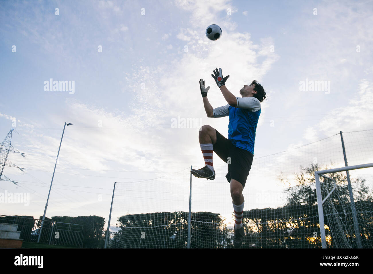 Goalkeeper trying to catch football Stock Photo - Alamy