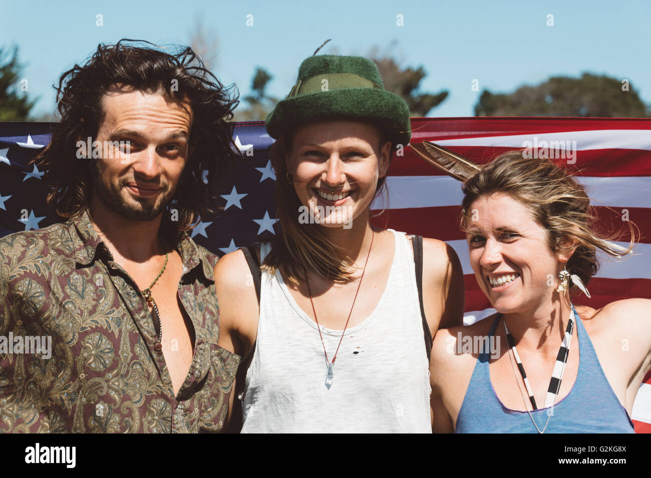 Portrait of three smiling hippies with US flag Stock Photo - Alamy