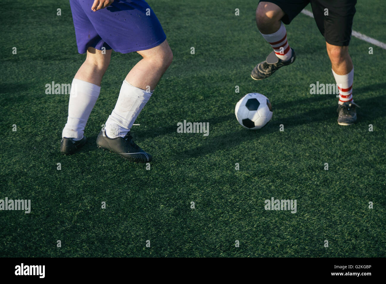 Legs of football players on football ground Stock Photo - Alamy