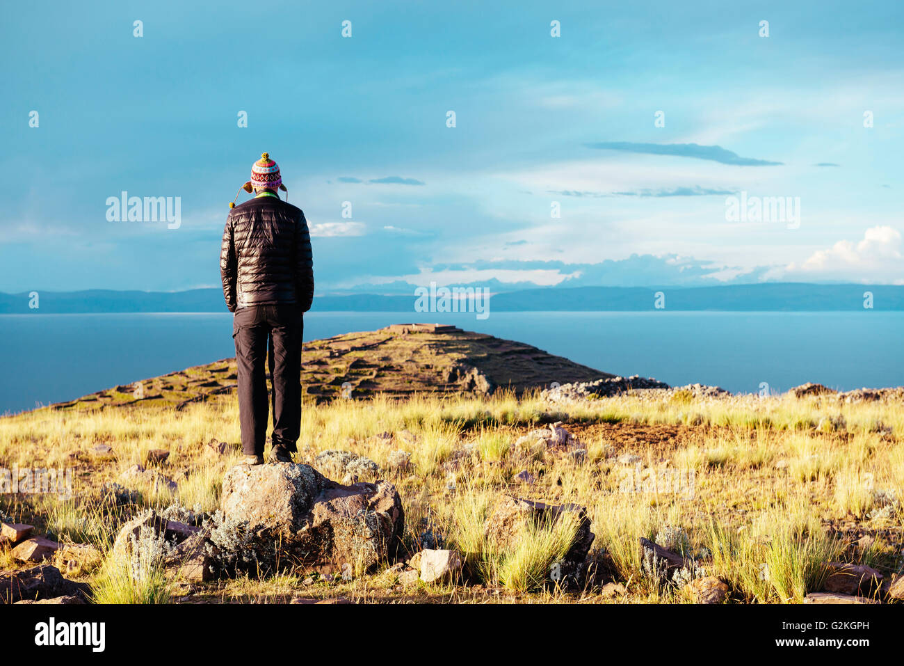 Peru, Amantani Island, man looking from Pachamama peak to Pachatata ...