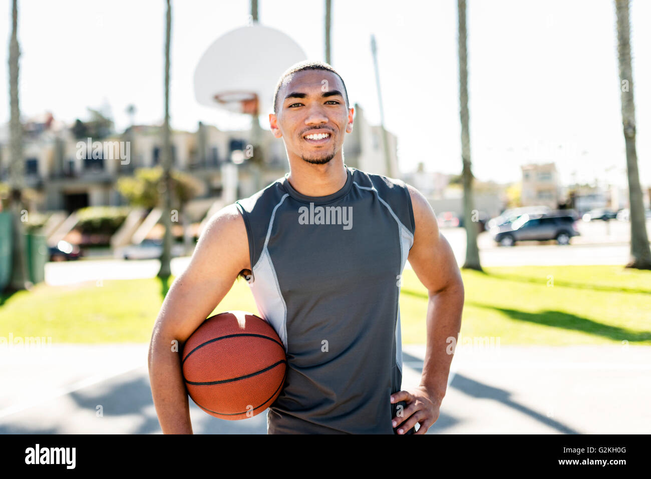 Portrait of confident basketball player on outdoor court Stock Photo ...