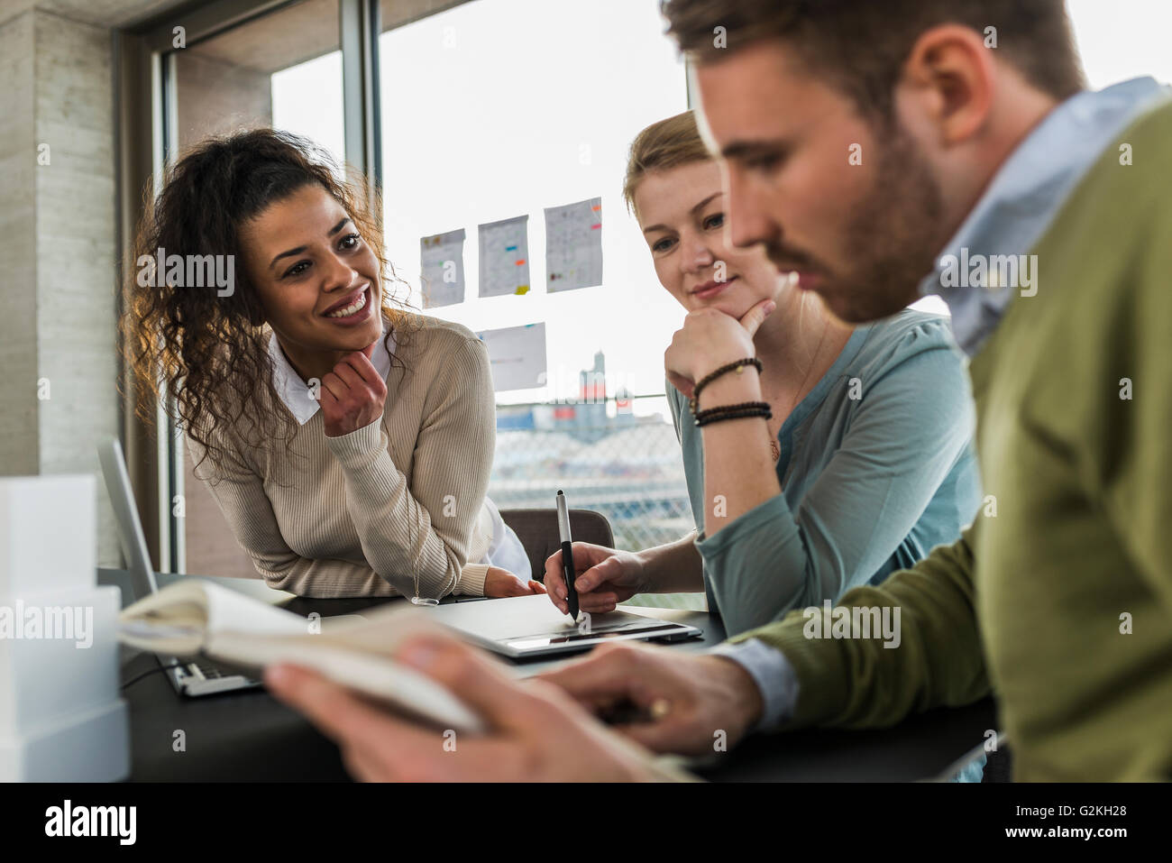 Three colleagues in office working together Stock Photo - Alamy