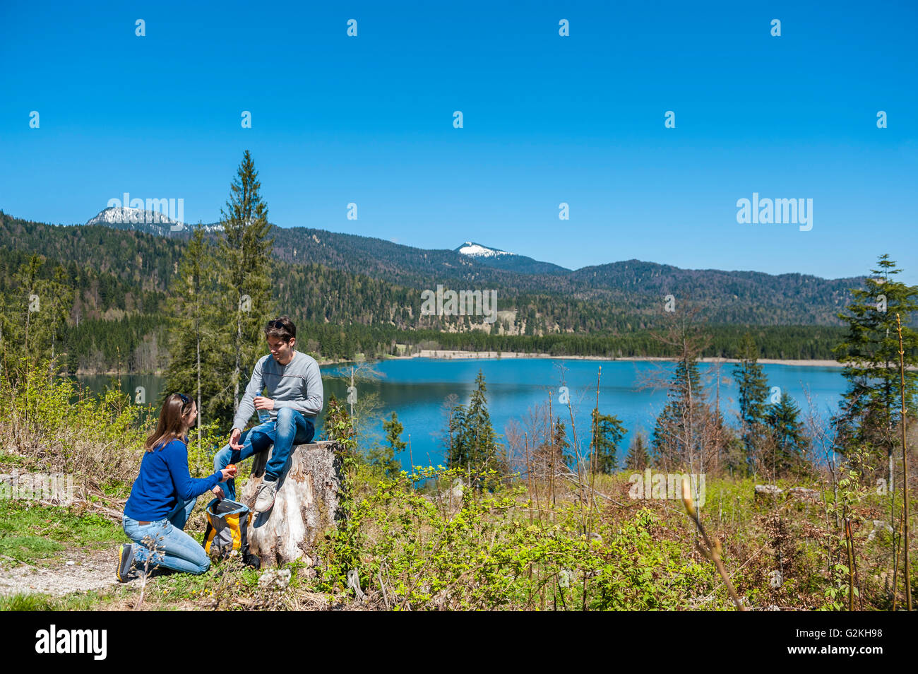 Germany, Bavaria, couple having a picnic at lake Barmsee Stock Photo ...
