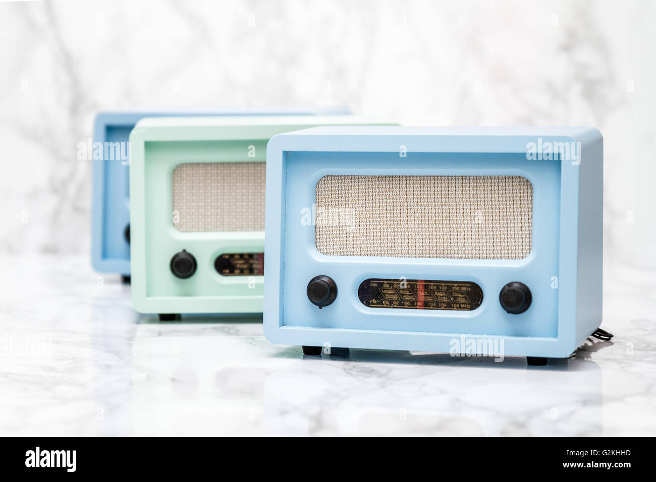 Blue and green radios with retro look on white marble background Stock ...