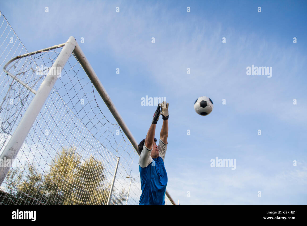 Football goalkeeper making a safe Stock Photo - Alamy