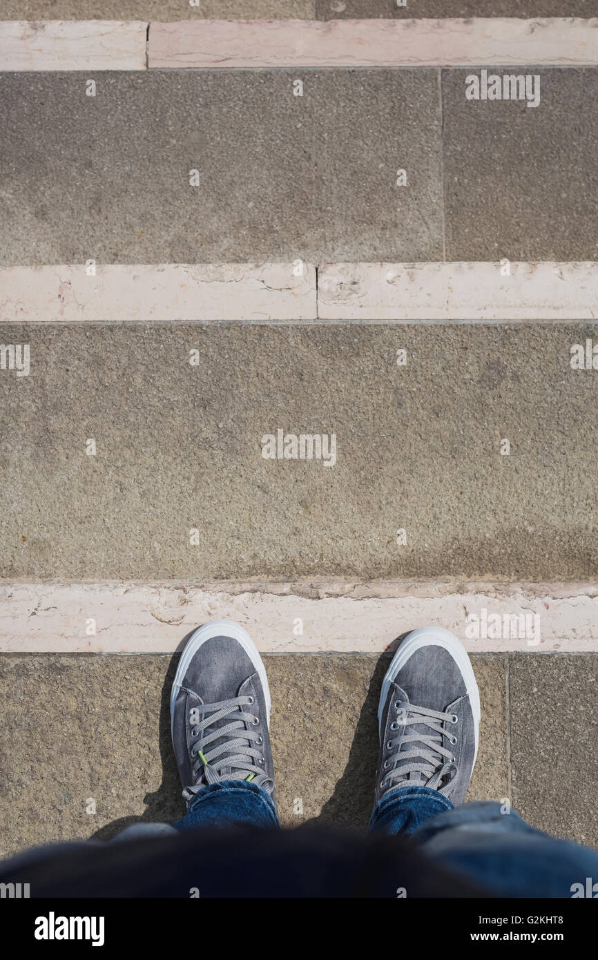 Man's feet on stone floor Stock Photo - Alamy
