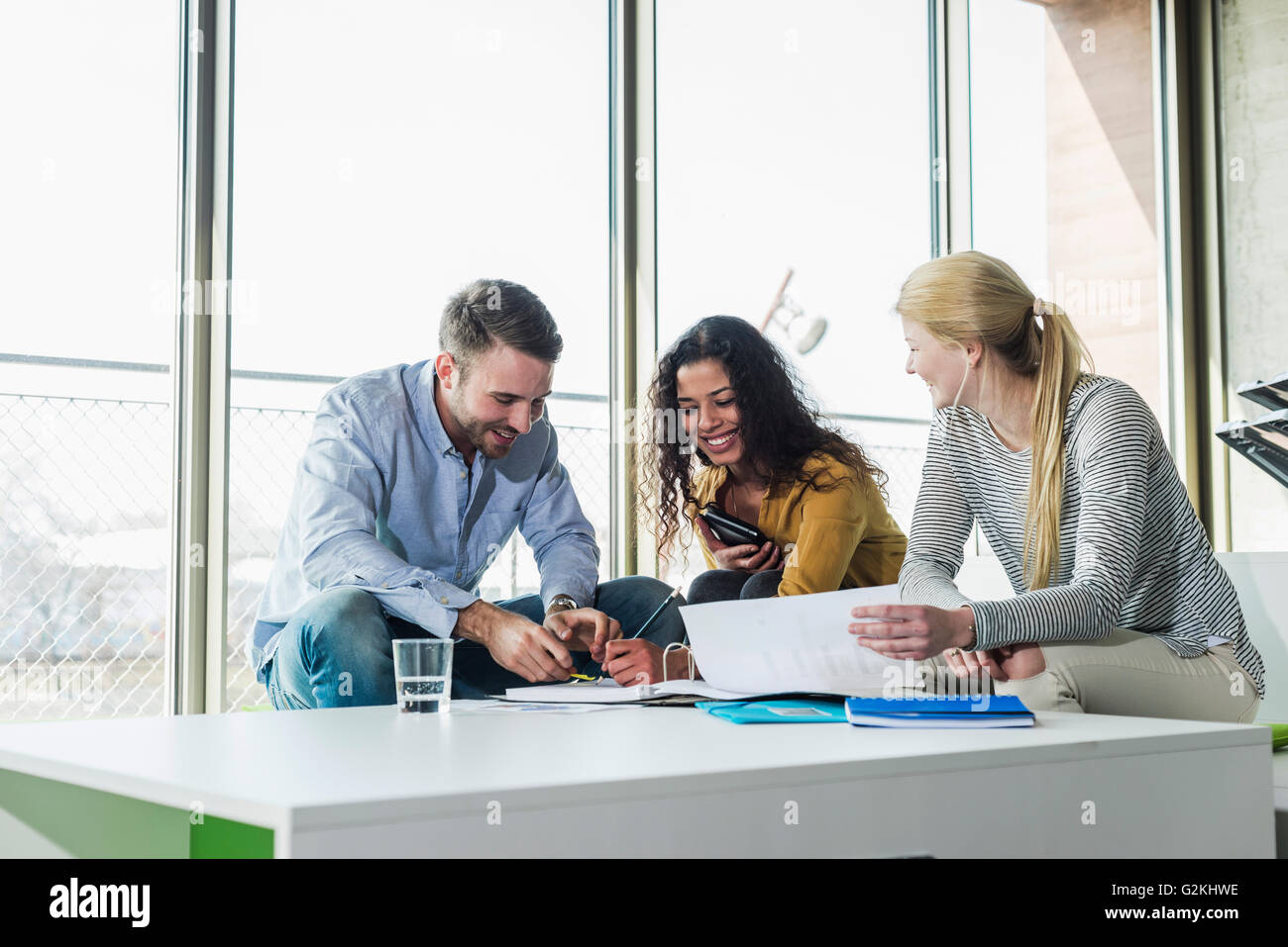 Three colleagues in office working together Stock Photo - Alamy