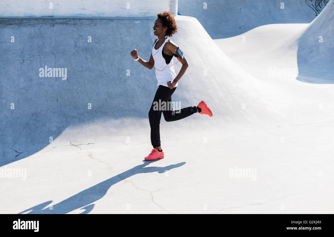 Young woman running in skatepark Stock Photo - Alamy