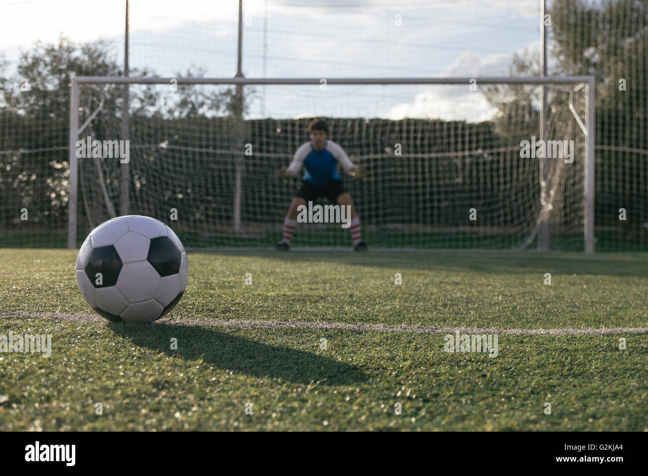 Football in front of a goal with a goalkeeper Stock Photo - Alamy