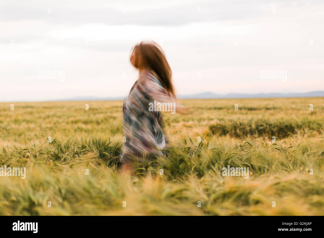 Woman dancing on a field Stock Photo - Alamy