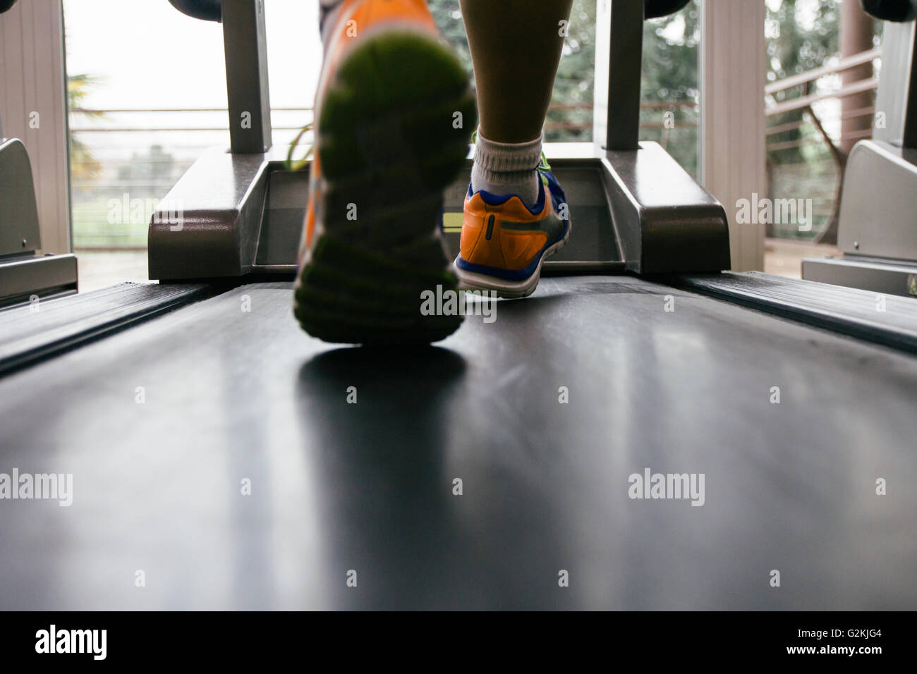 Feet of man running on a treadmill Stock Photo - Alamy
