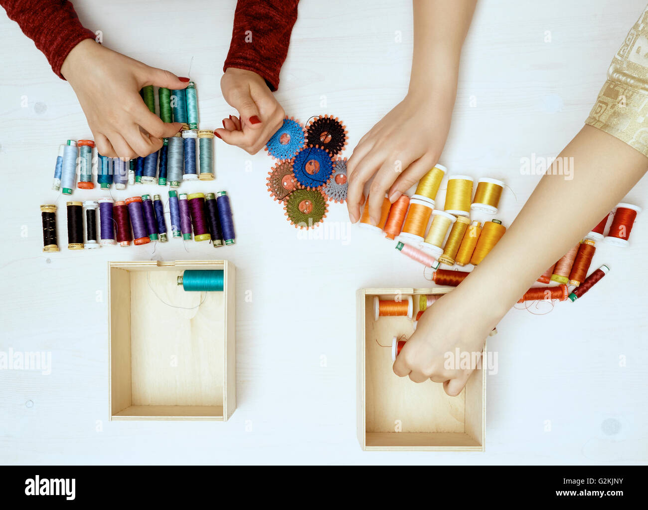 Hands sorting sewing utensils Stock Photo - Alamy