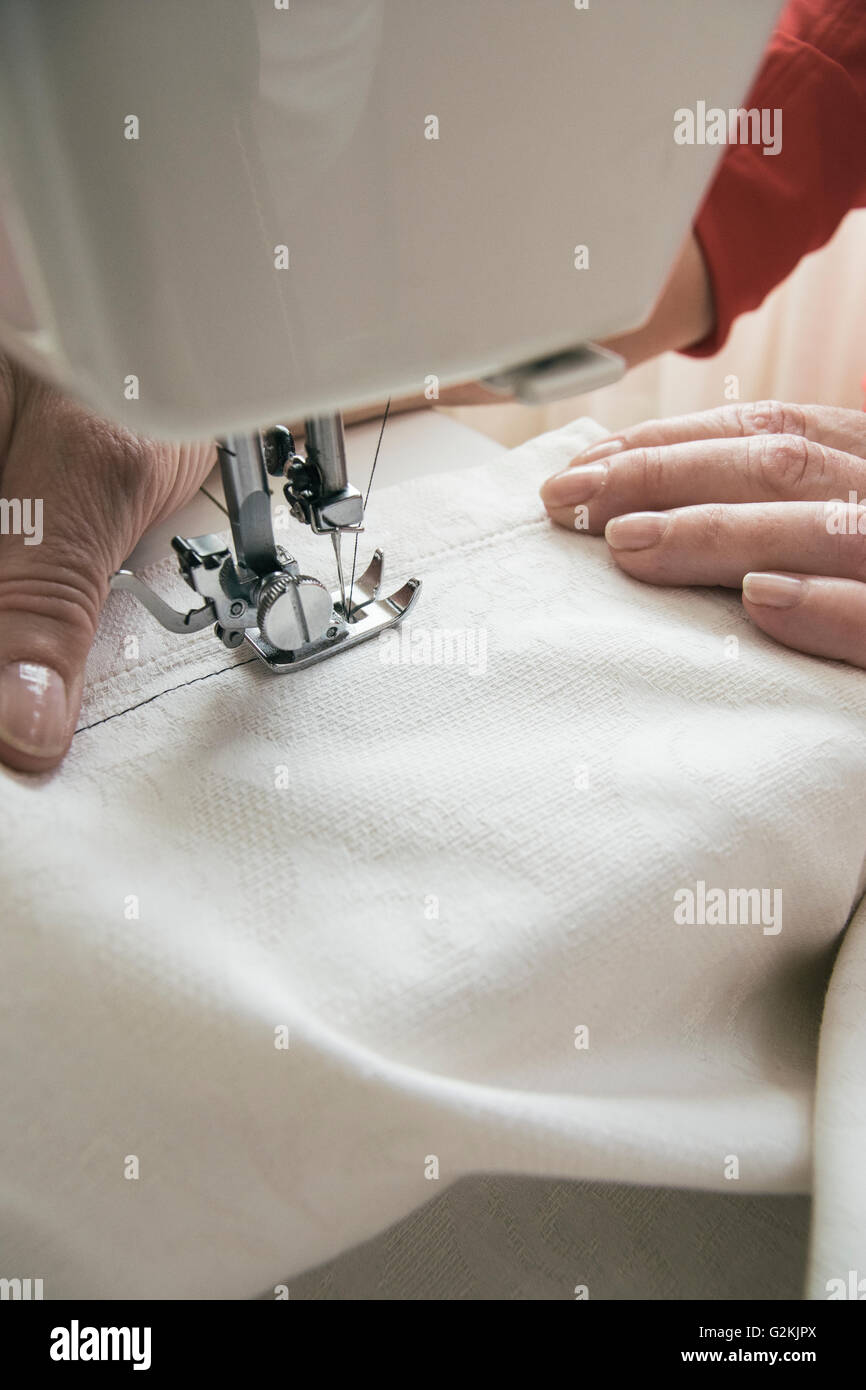 Woman using a sewing machine Stock Photo - Alamy