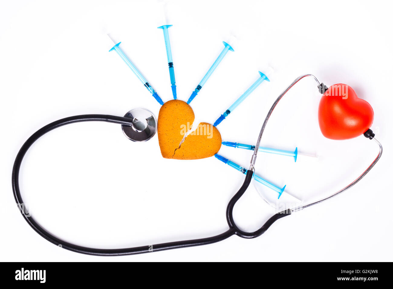 healing a broken heart with blue syringe and a sthethoscope on white ...