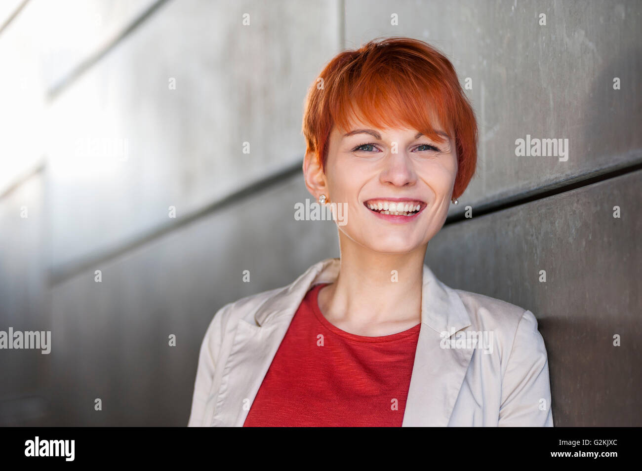 Portrait of smiling redheaded young woman Stock Photo - Alamy