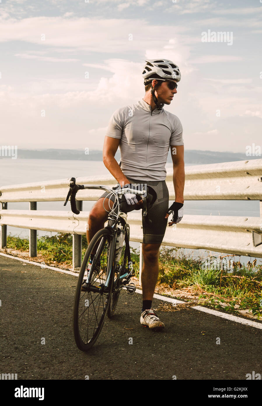 Cyclist with his racing bike in the evening Stock Photo - Alamy