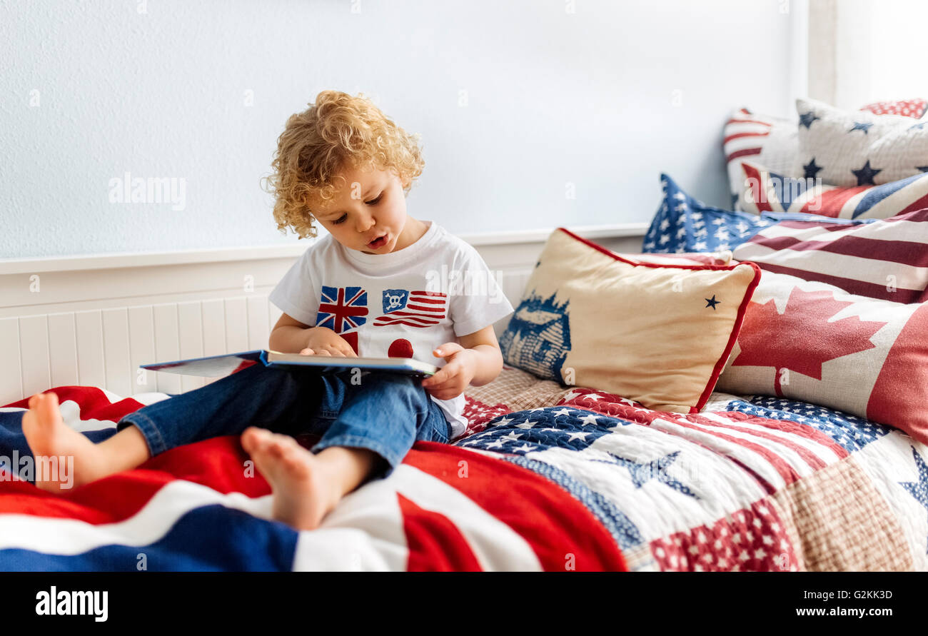 Little boy watching picture book Stock Photo - Alamy