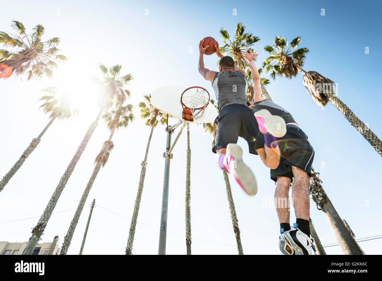 Two young men playing basketball on an outdoor court Stock Photo - Alamy