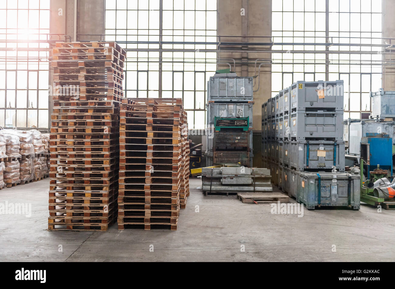 Pallets in factory hall Stock Photo - Alamy