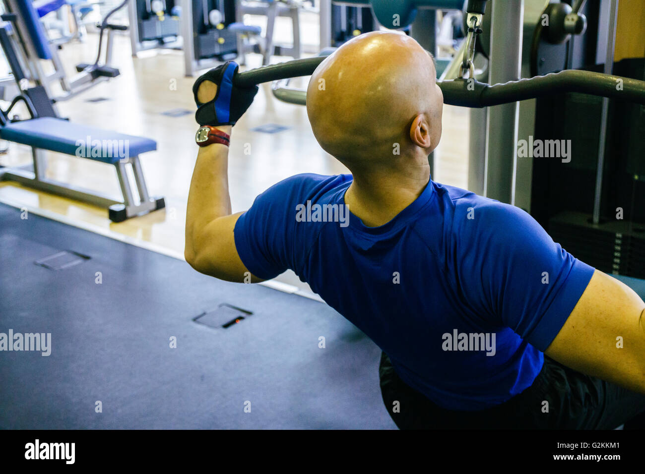 Man doing chest exercises in a gym machine Stock Photo - Alamy