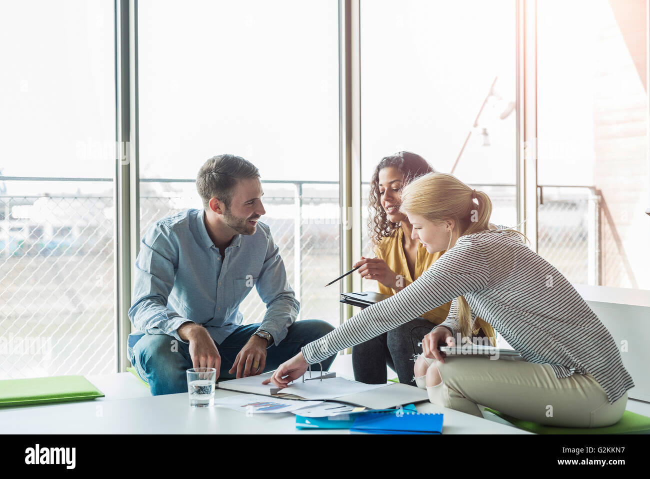 Three colleagues in office working together Stock Photo - Alamy