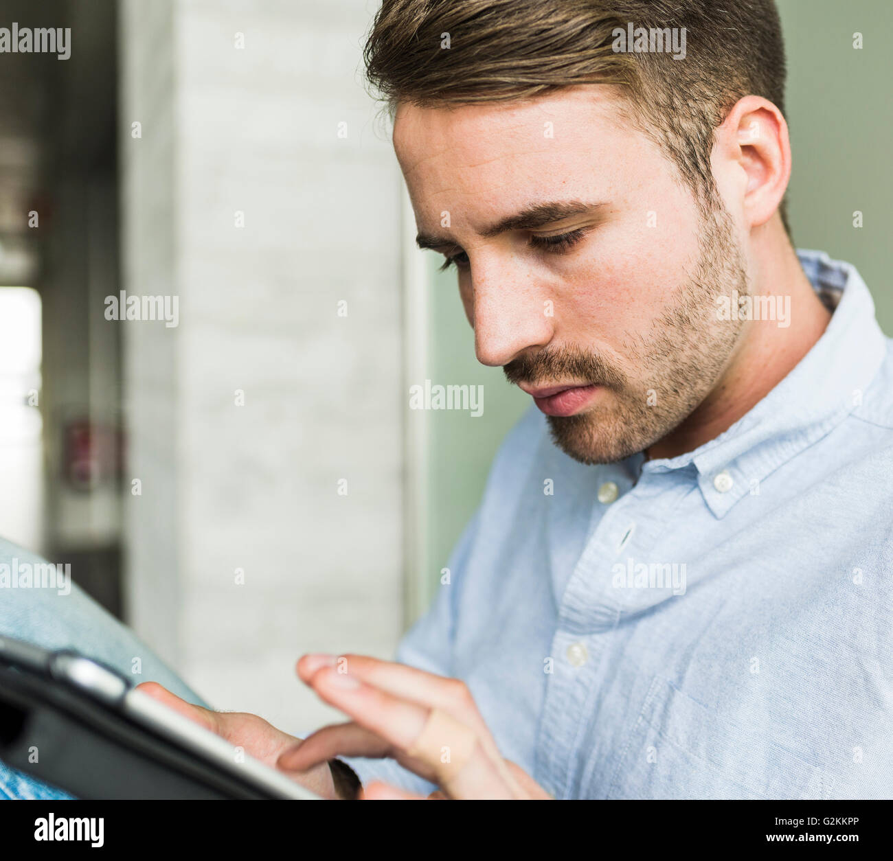 Young man using digital tablet Stock Photo - Alamy