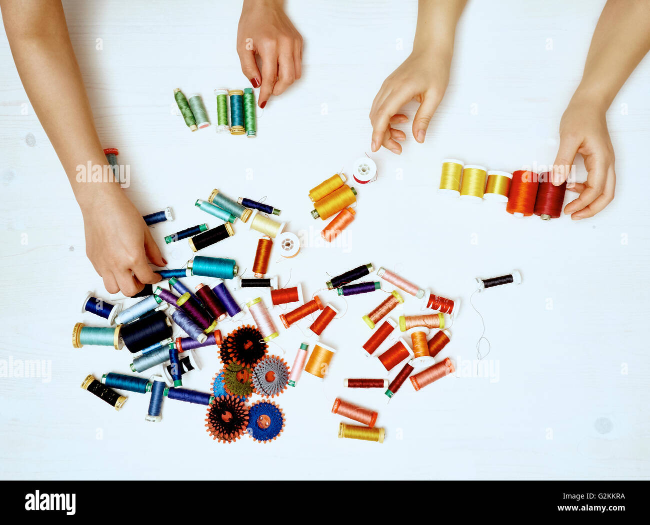 Hands sorting sewing utensils Stock Photo - Alamy