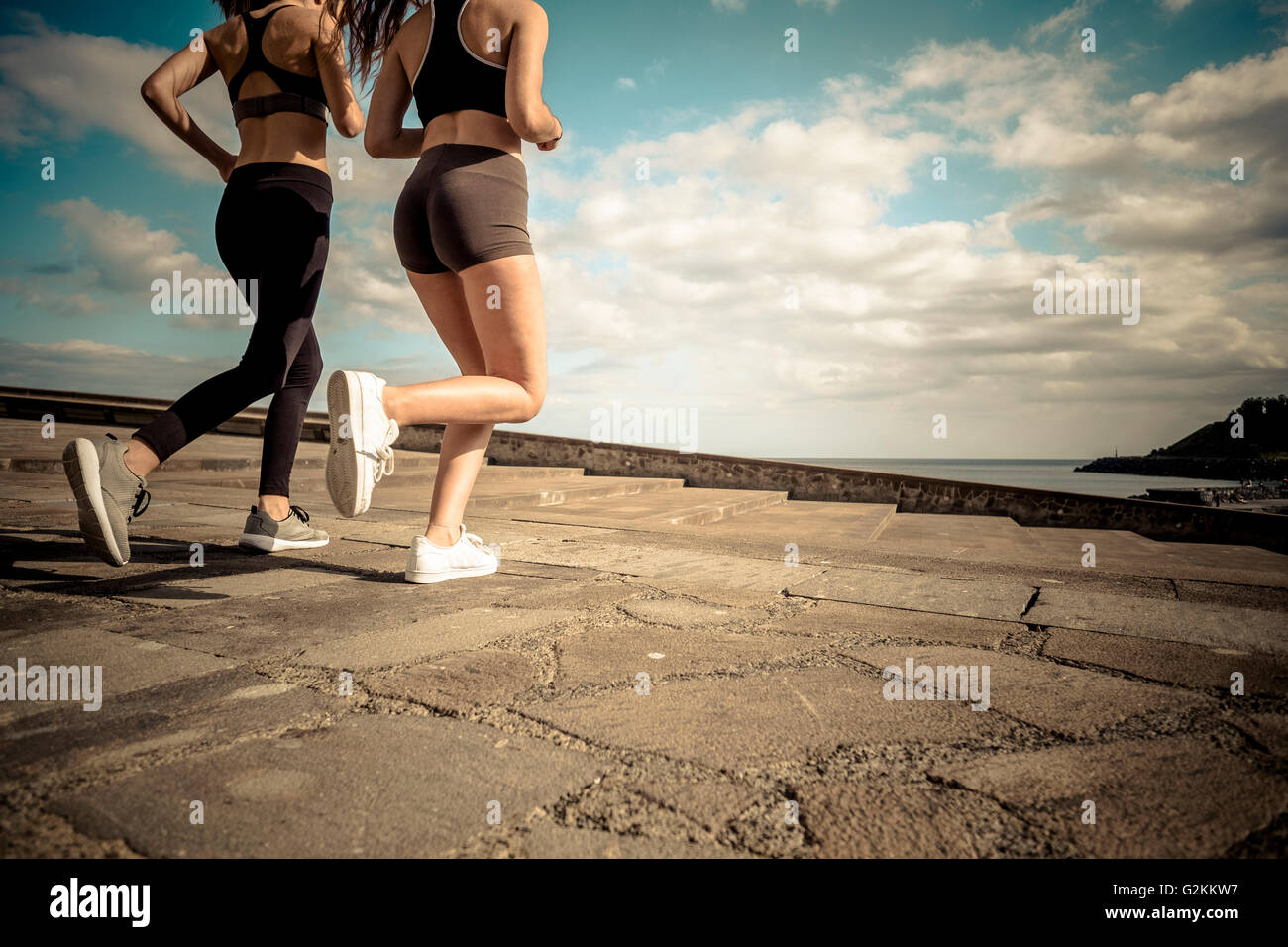 Two friends running into the ocean hi-res stock photography and images ...