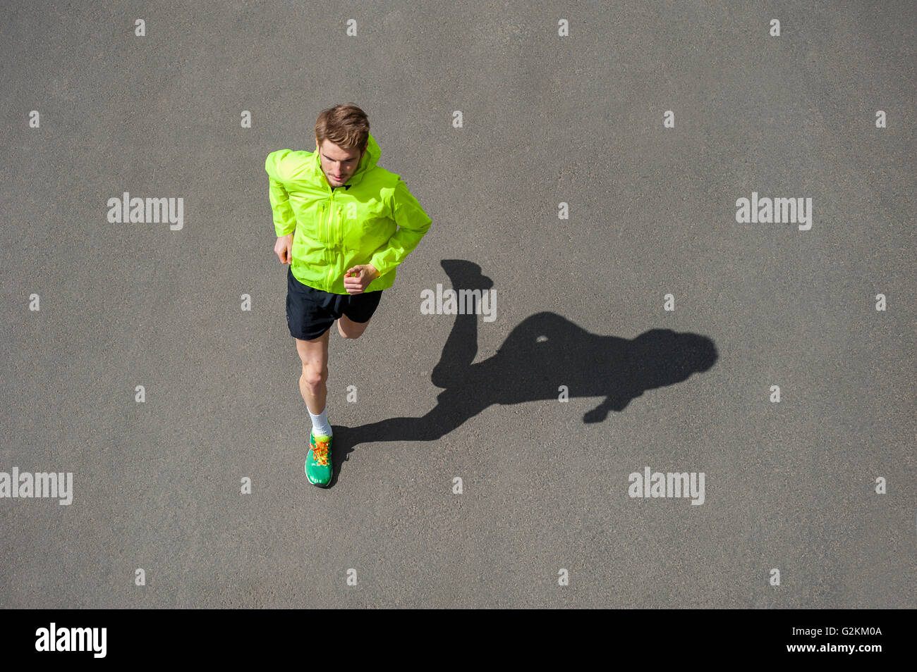 Young man jogging, concrete floor Stock Photo - Alamy