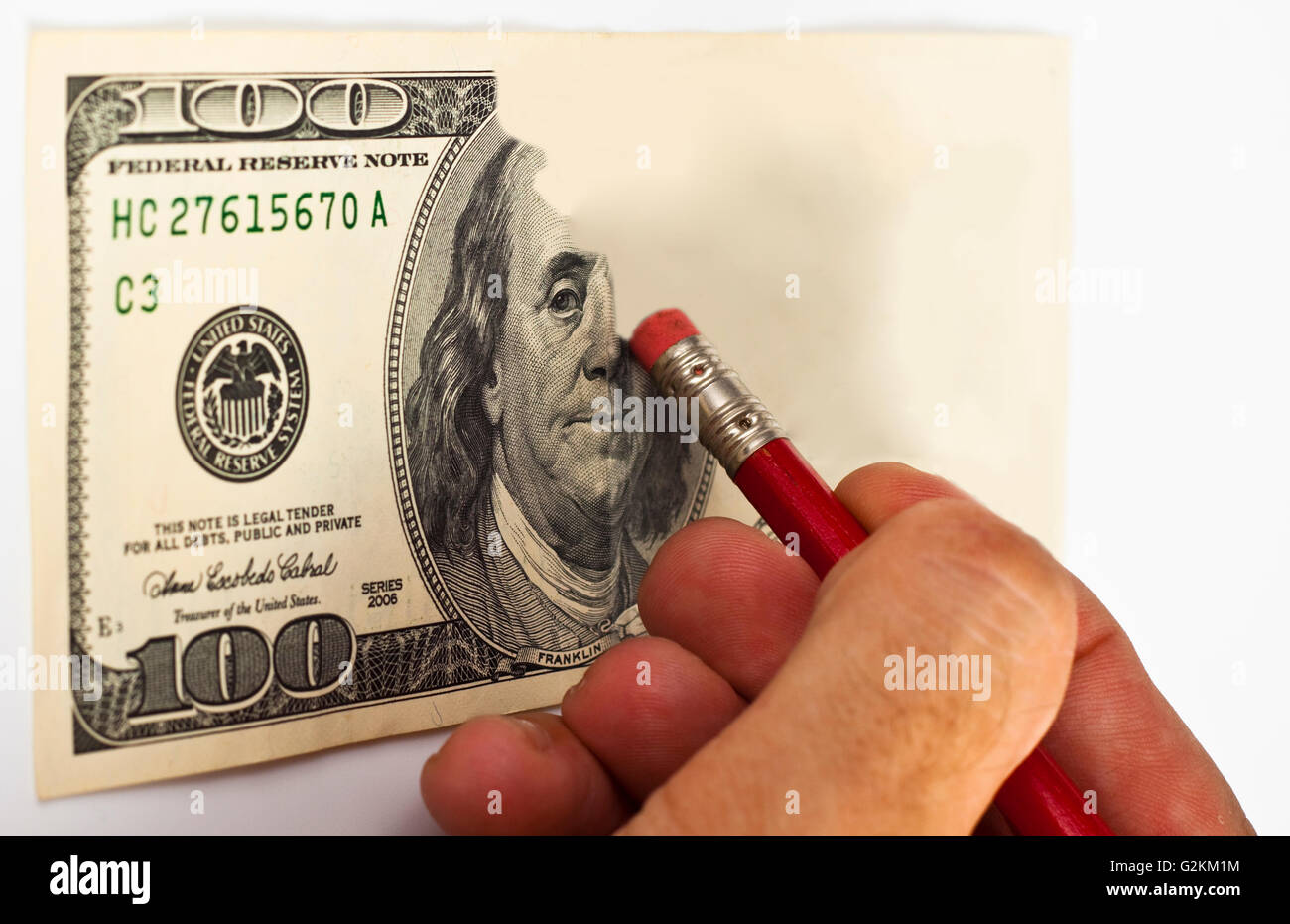 erasing a 100 dollar bill with a red pencil and eraser Stock Photo - Alamy