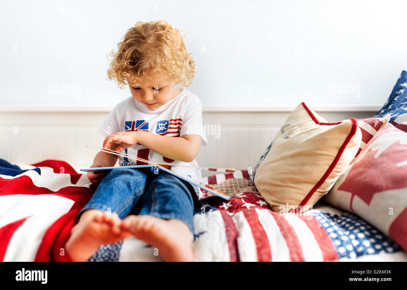 Little boy watching picture book Stock Photo - Alamy
