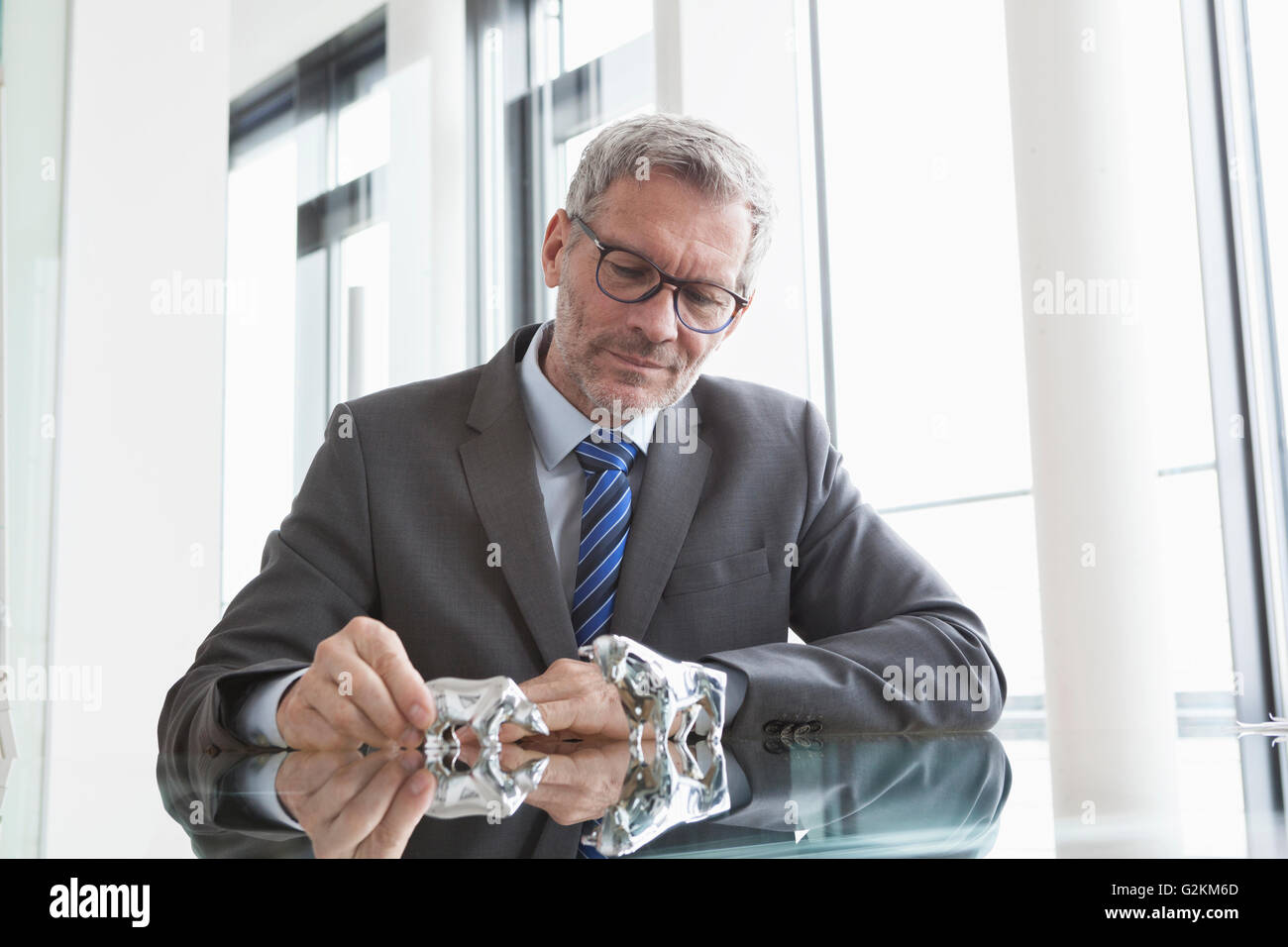 Businessman observing stock market, bull and bear figurines Stock Photo ...