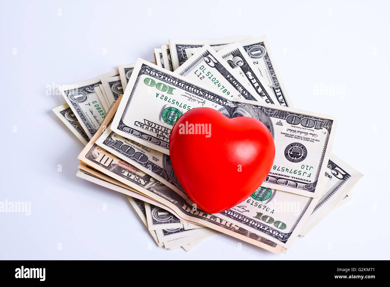 red heart and dollar bills on white background Stock Photo - Alamy