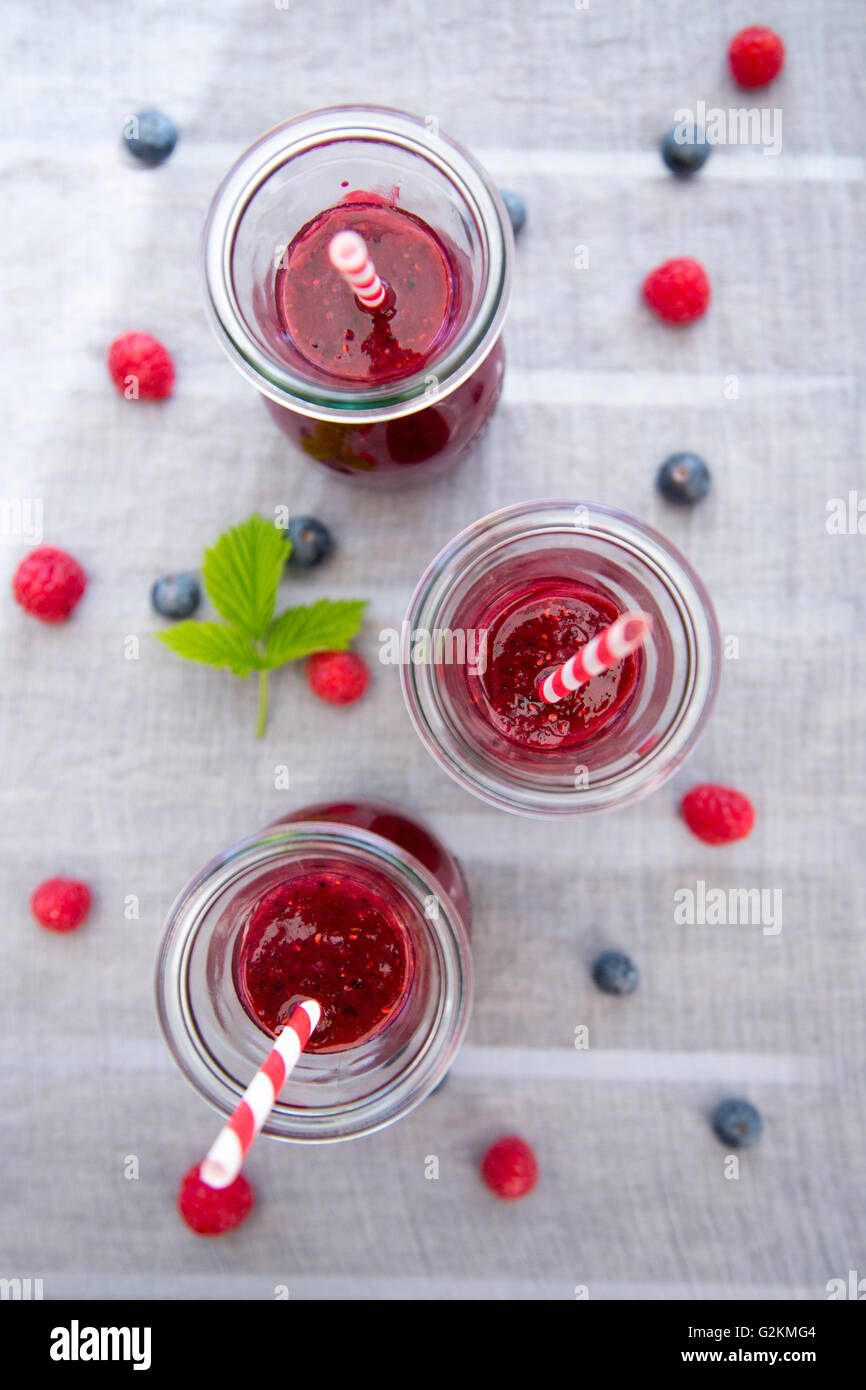 Three glasses of raspberry blueberry smoothies Stock Photo - Alamy