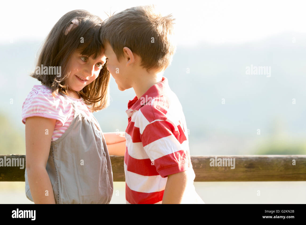 Little boy and girl face to face Stock Photo - Alamy