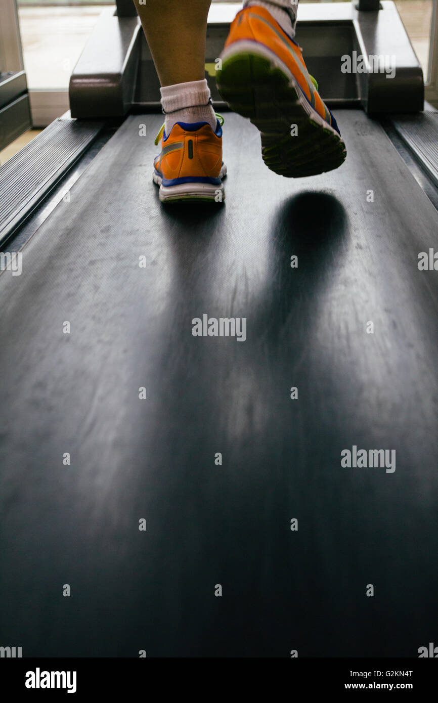 Feet of man running on a treadmill Stock Photo - Alamy