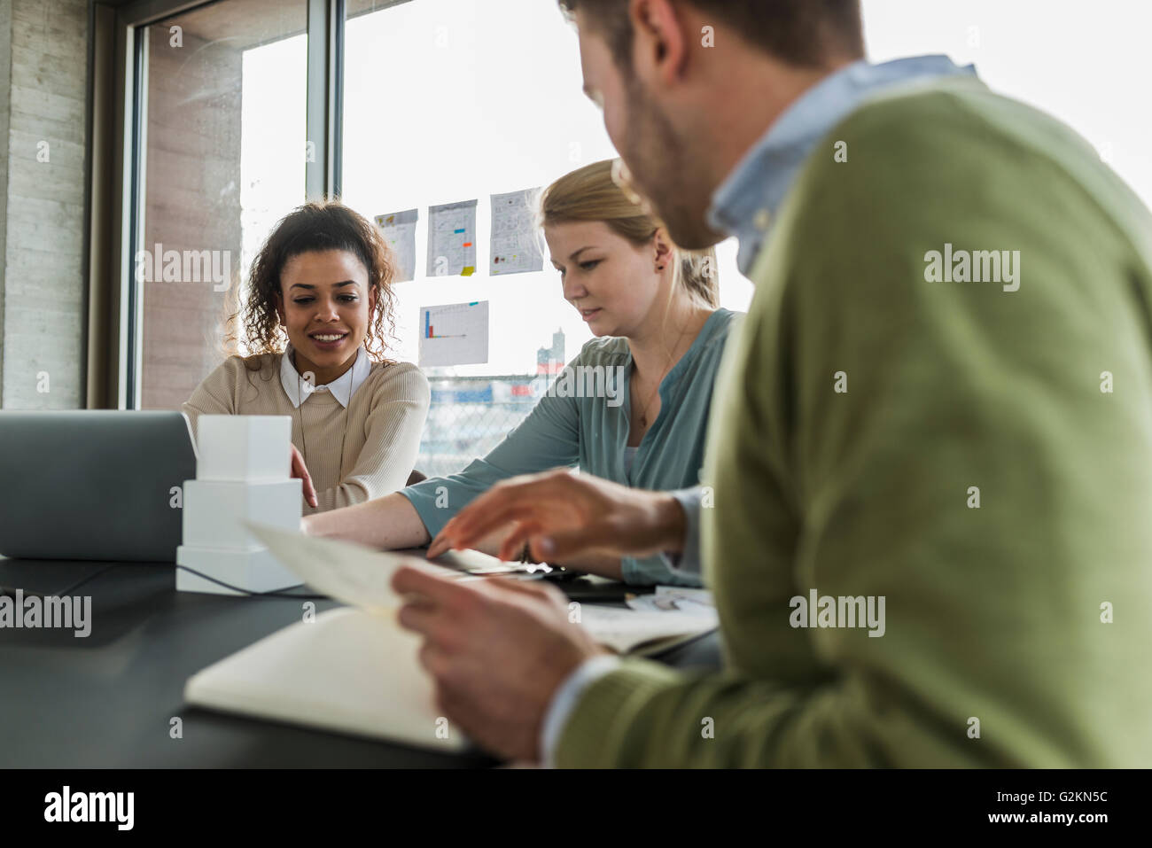 Three colleagues in office working together Stock Photo - Alamy