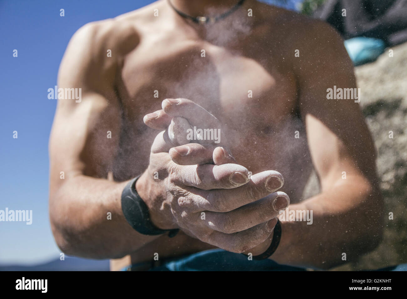 Shirtless climber coating his hands in powder chalk magnesium Stock ...