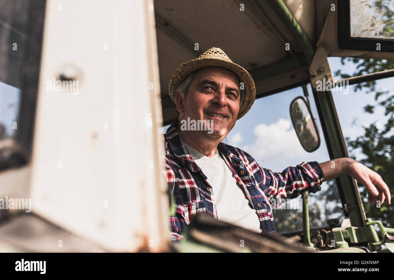 Portrait of smiling farmer on tractor Stock Photo - Alamy