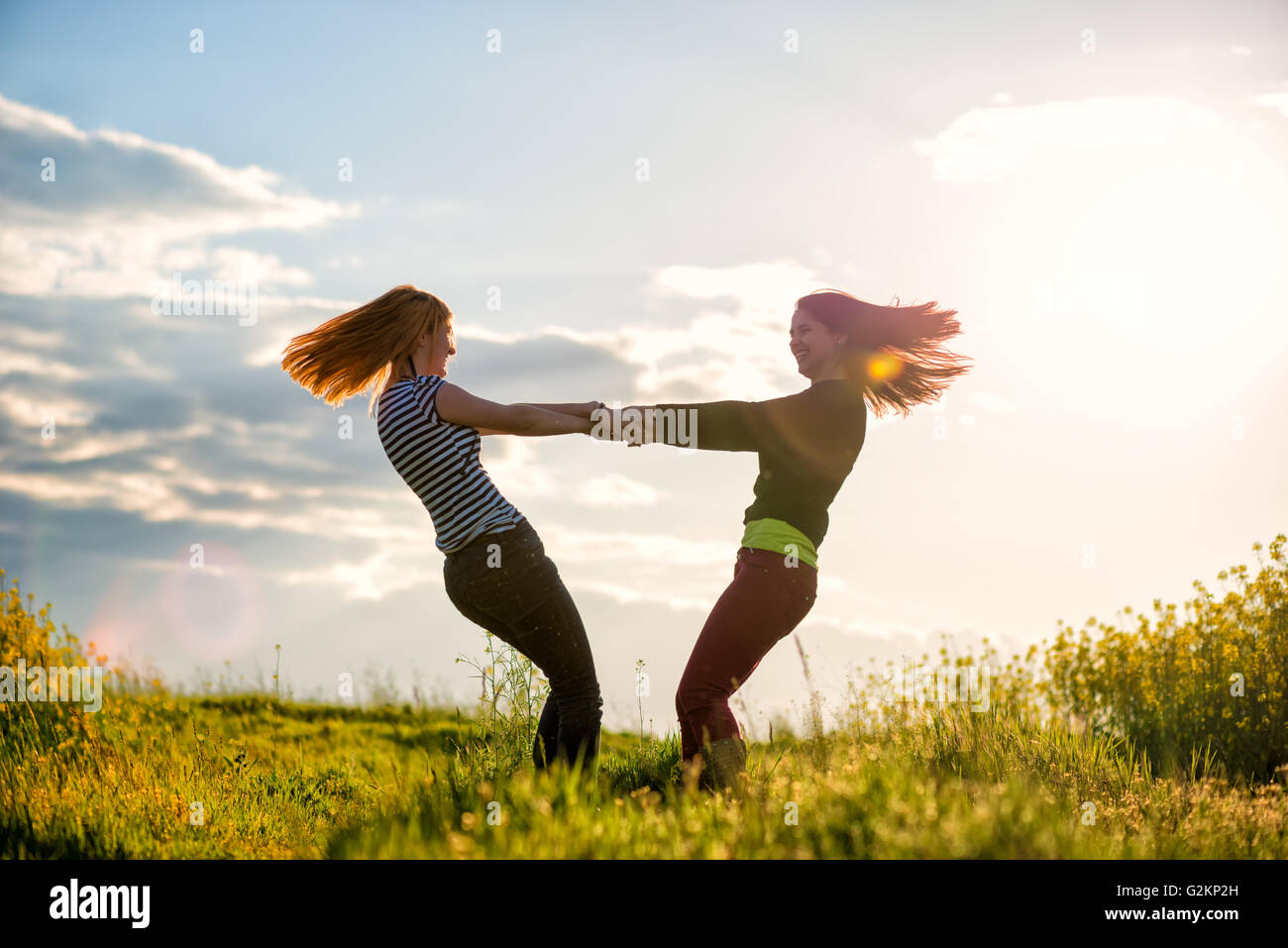 two beautiful girl having fun together at the sunset Stock Photo - Alamy