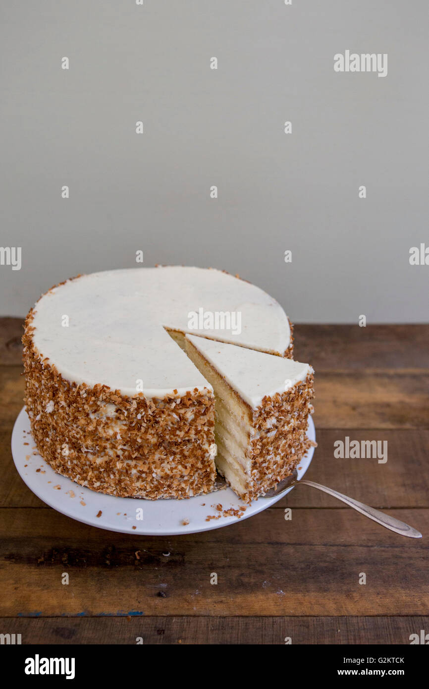 Coconut Cake with One Slice Cut Stock Photo - Alamy