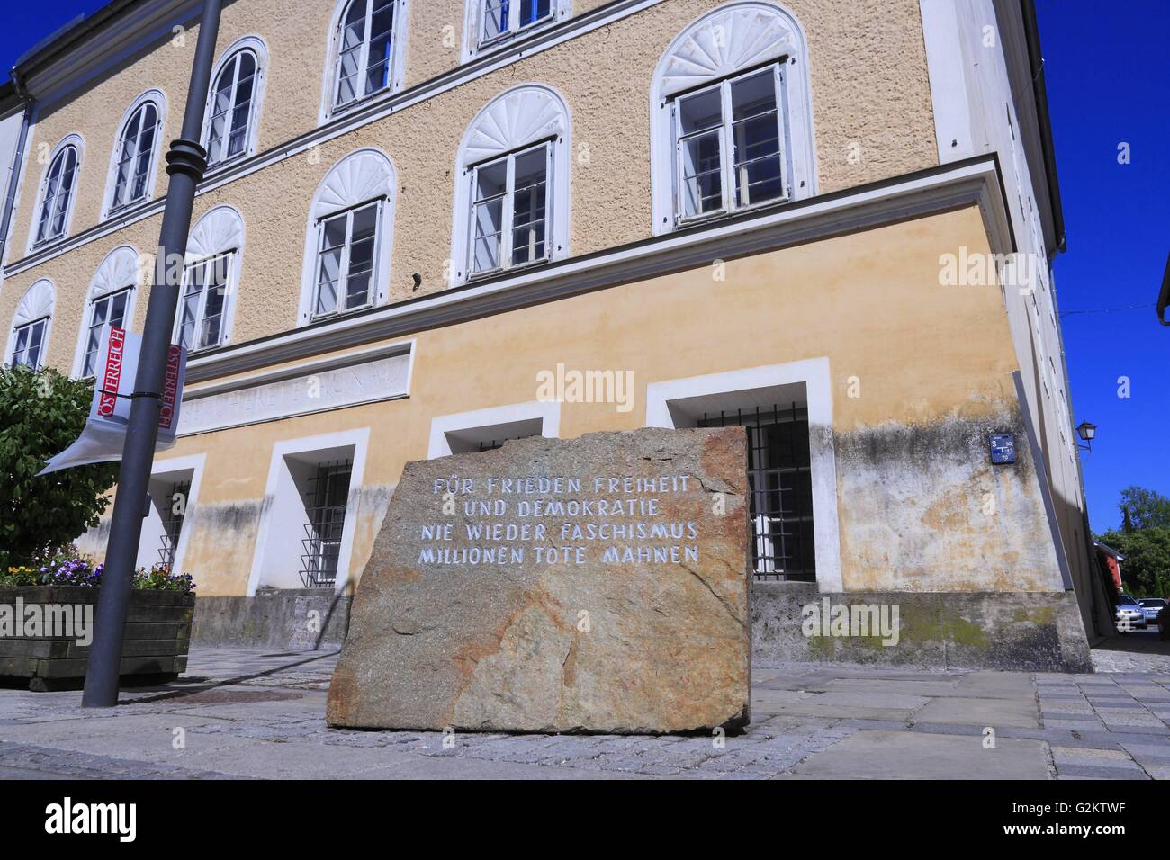 A memorial stone made out of granite from Mauthausen stands in front of ...