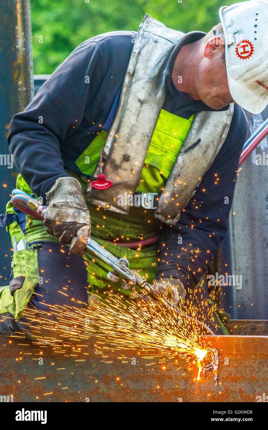 Cutting a steel beam with flying sparks, Neckar river construction site ...
