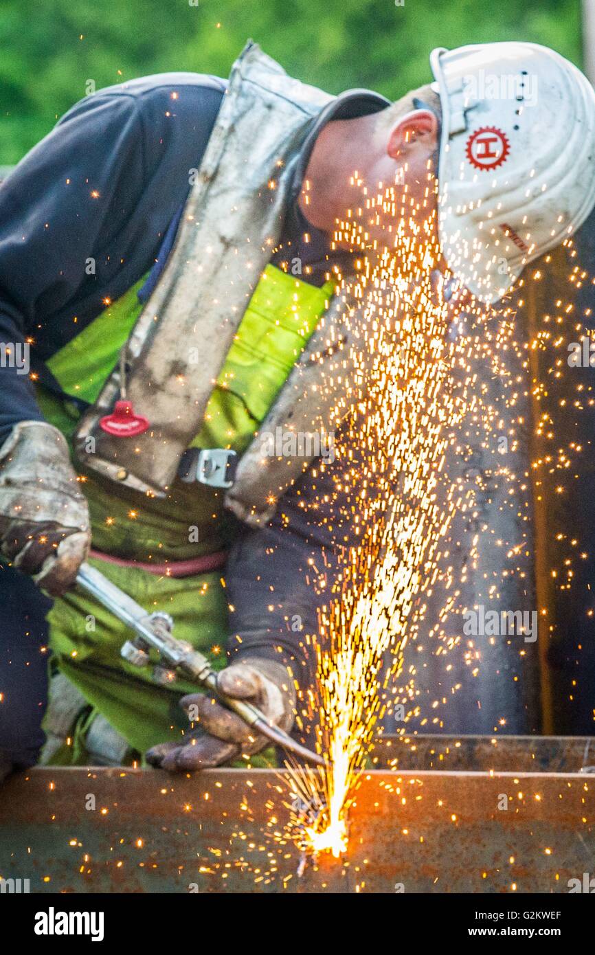 Cutting a steel beam with flying sparks, Neckar river construction site ...